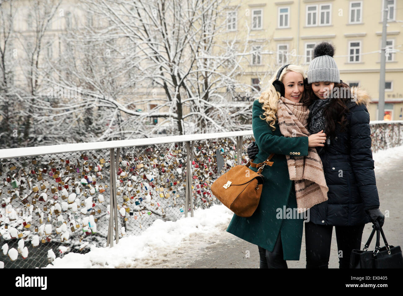 Two mid adult women wearing winter clothes Stock Photo - Alamy