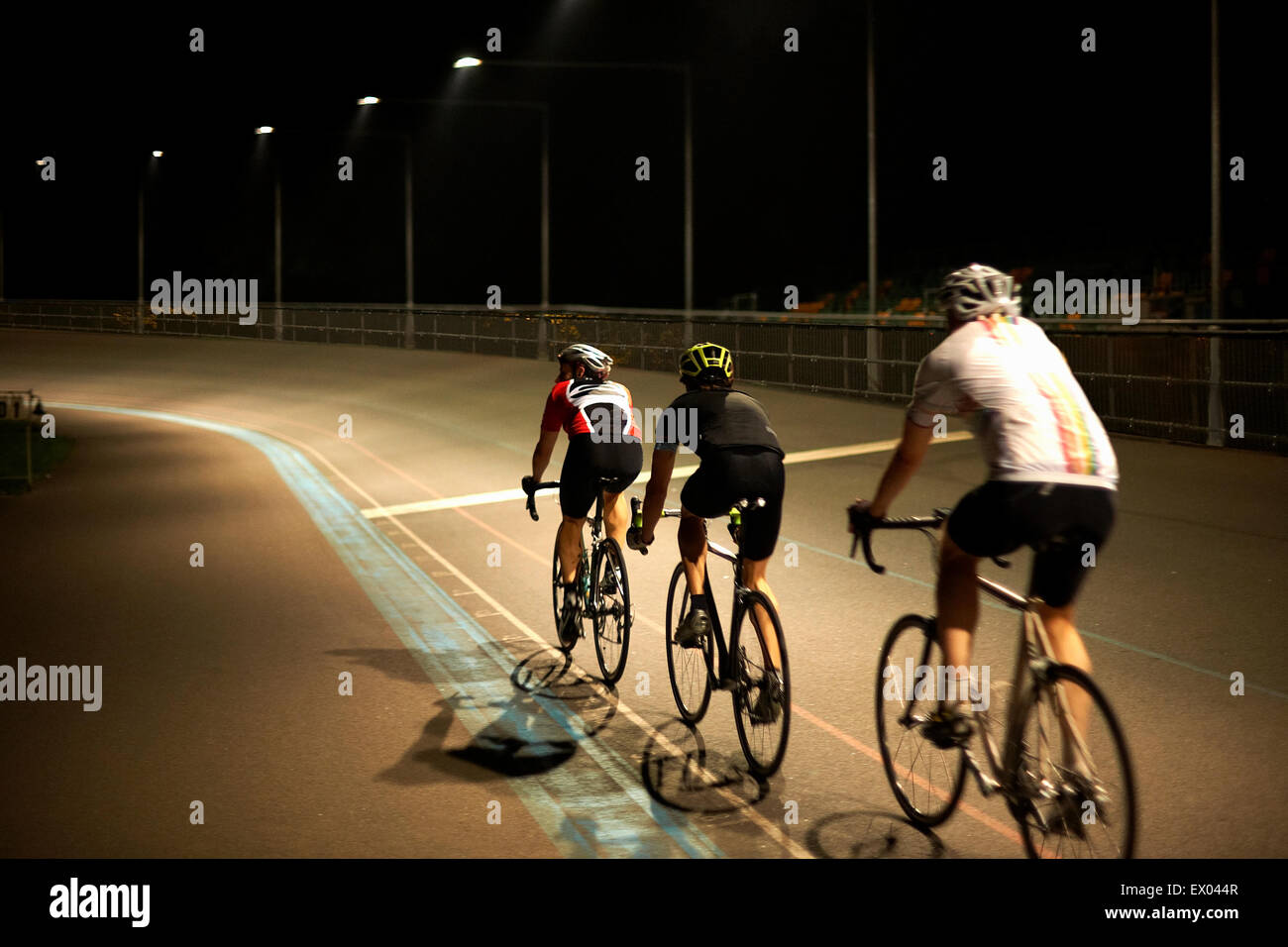Cyclists cycling on track at velodrome, rear view Stock Photo - Alamy