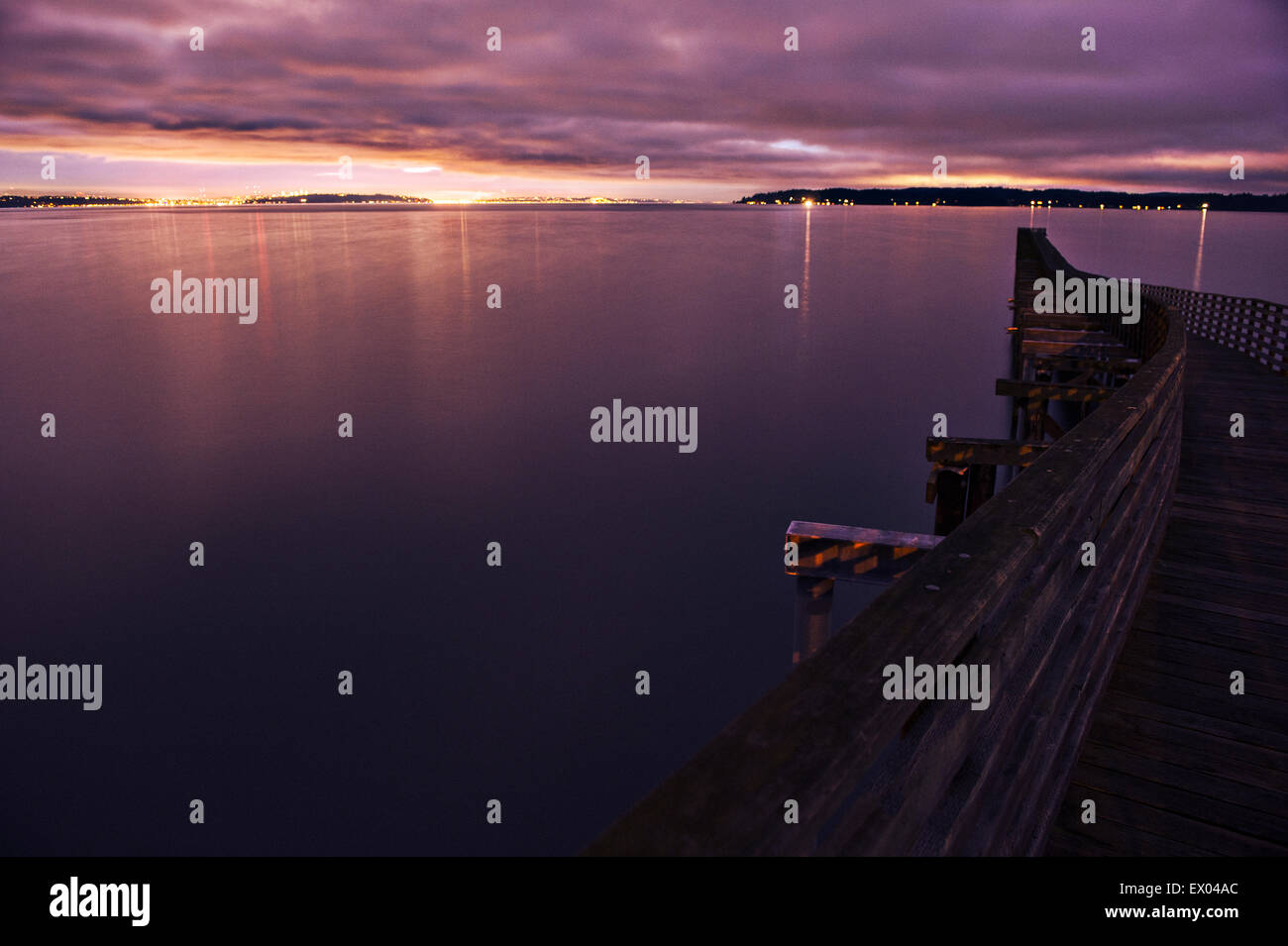 Silhouetted view of winding wooden pier over Puget Sound at night ...