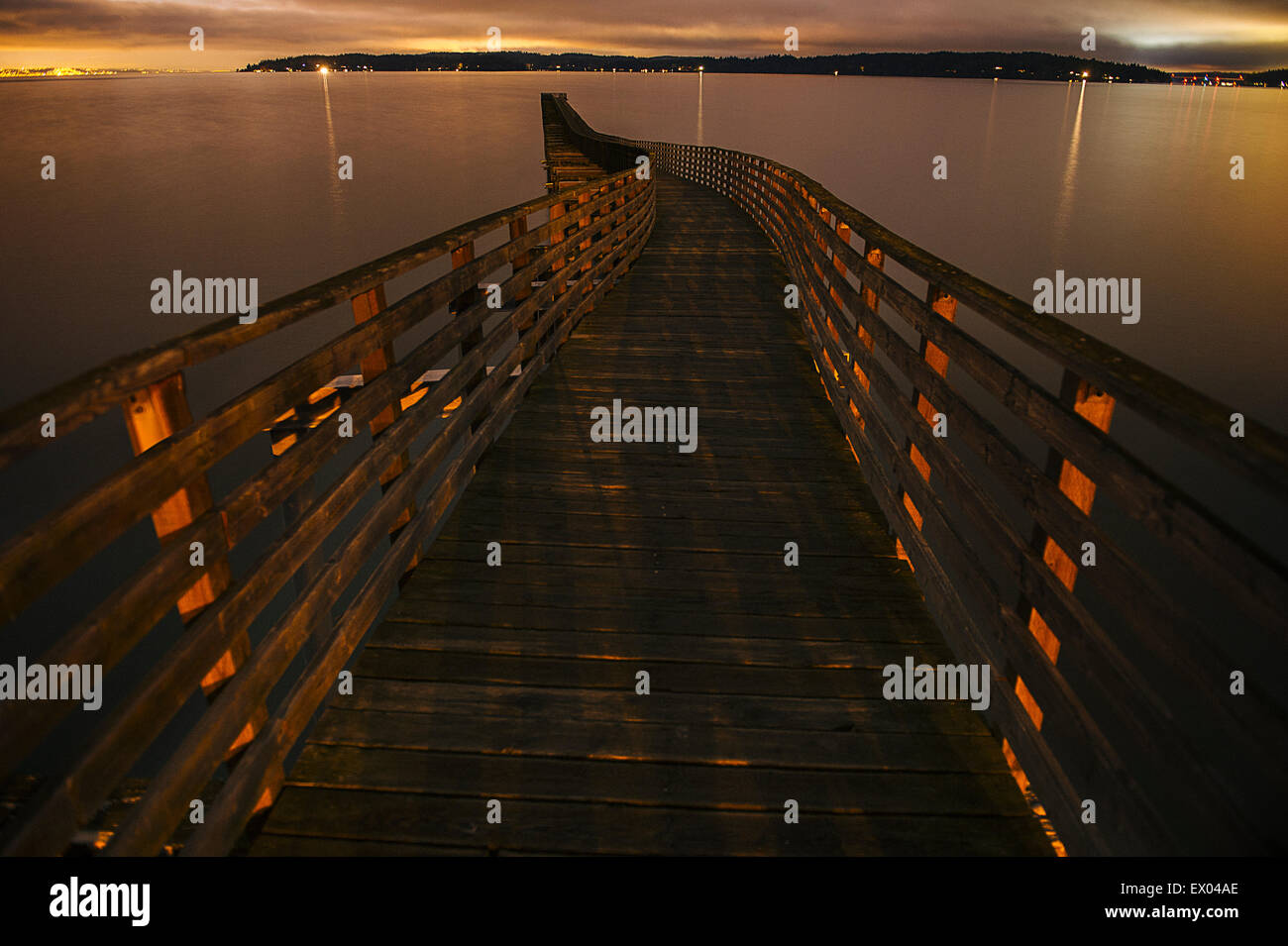 View of winding wooden pier over Puget Sound at night, Seattle ...