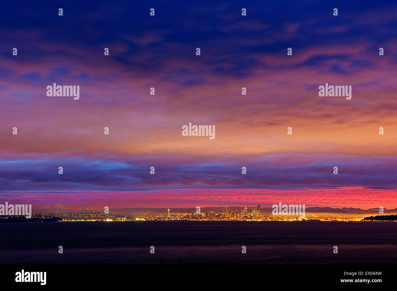 Distant view of city lights over Puget Sound at night, Seattle ...