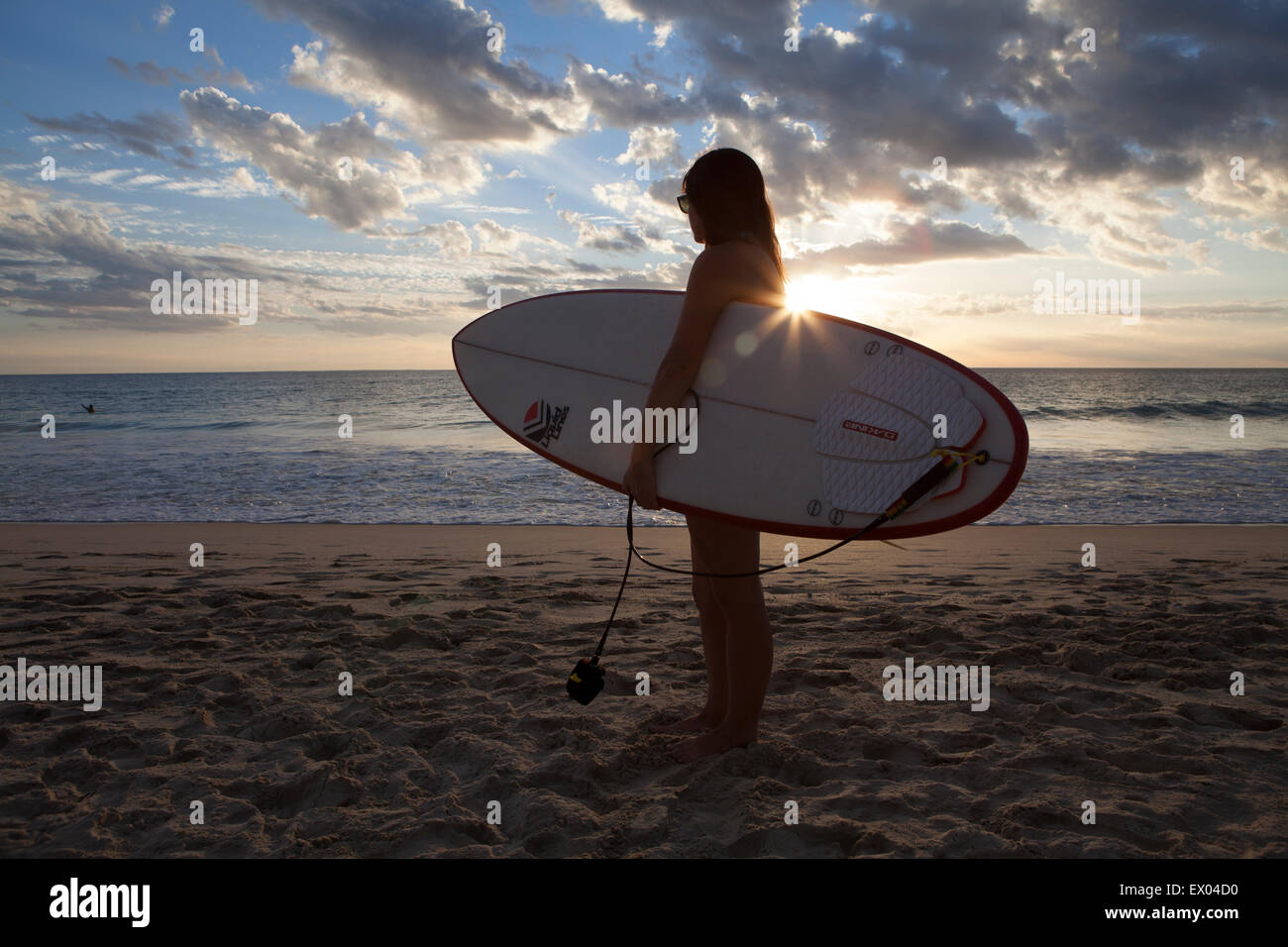 Silhouette of a woman carrying surfboard hi-res stock photography and ...