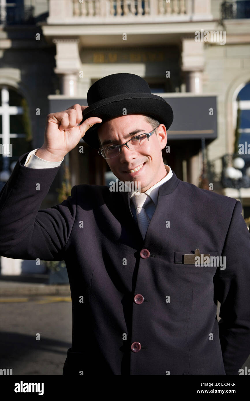 Portrait of polite man holding bowler hat Stock Photo - Alamy