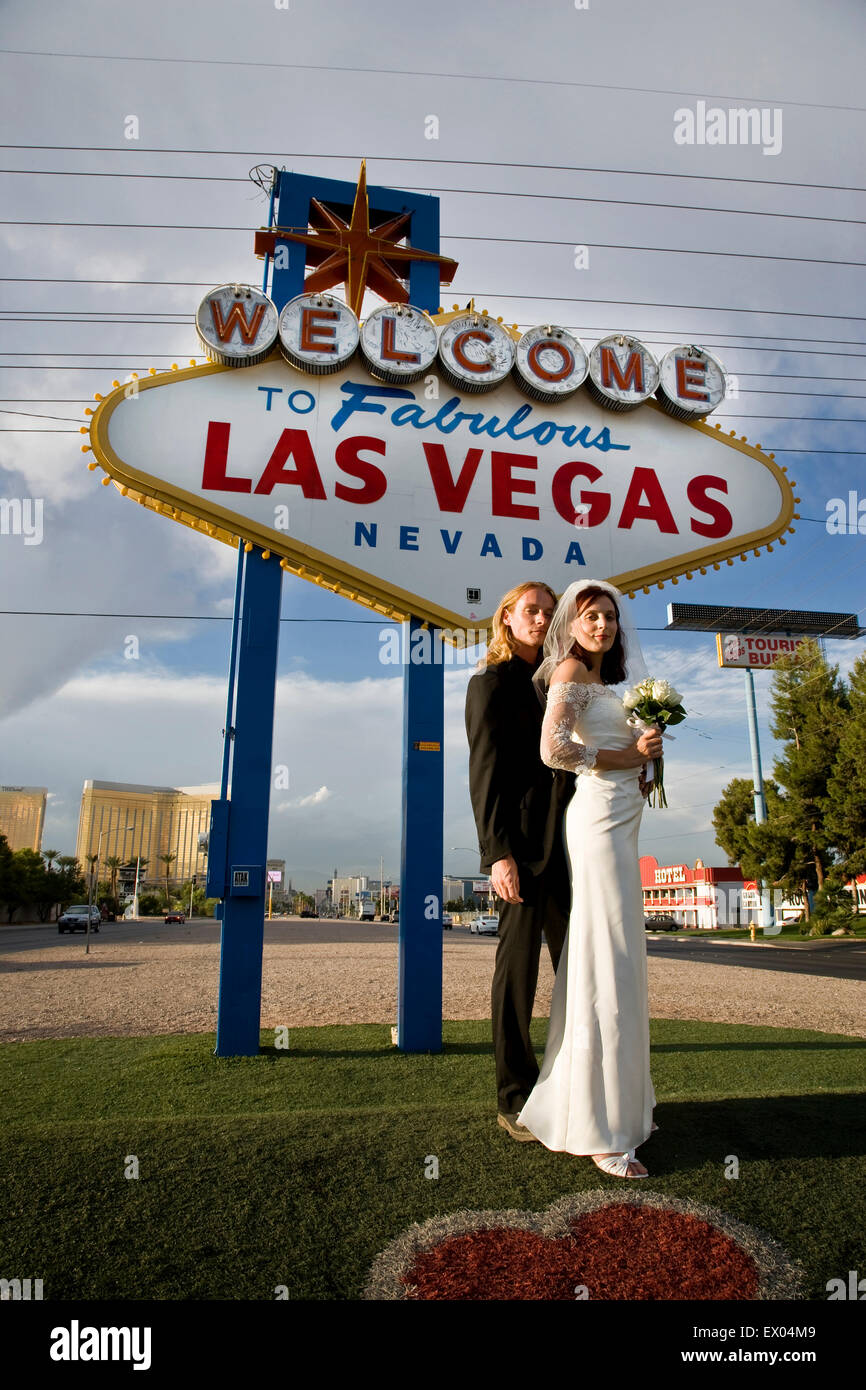Portrait Of Newly Married Couple In Front Of The Welcome To Las Vegas