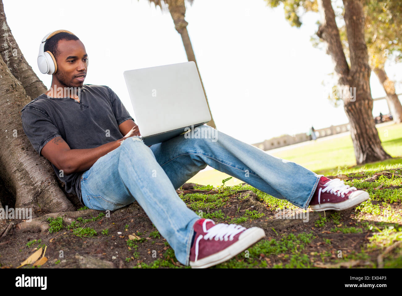 Person Leaning Against A Tree