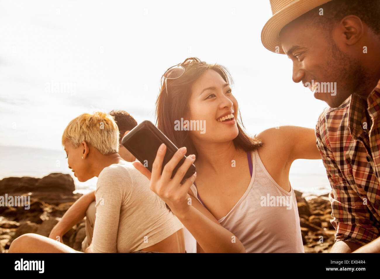 Group of friends fooling around on beach Stock Photo - Alamy
