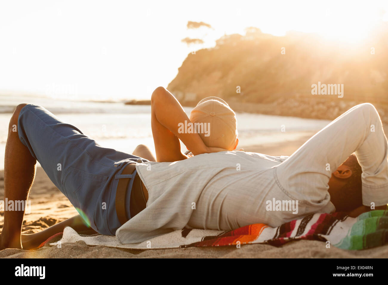 Young couple lying together on beach, rear view Stock Photo - Alamy