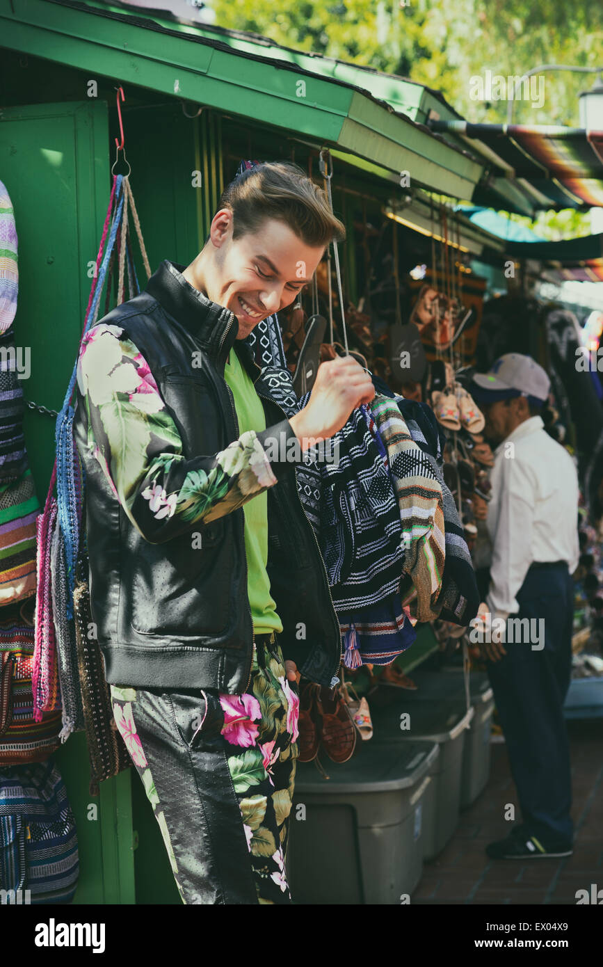 A male model looking down laughing and smiling with his eyes closed.He ...