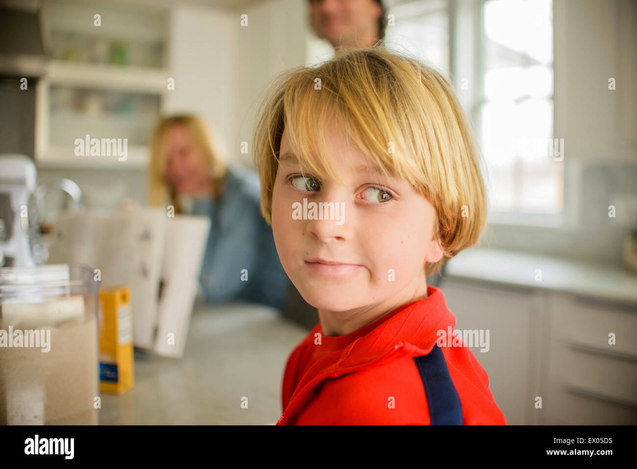 Portrait of boy looking sideways in kitchen Stock Photo - Alamy