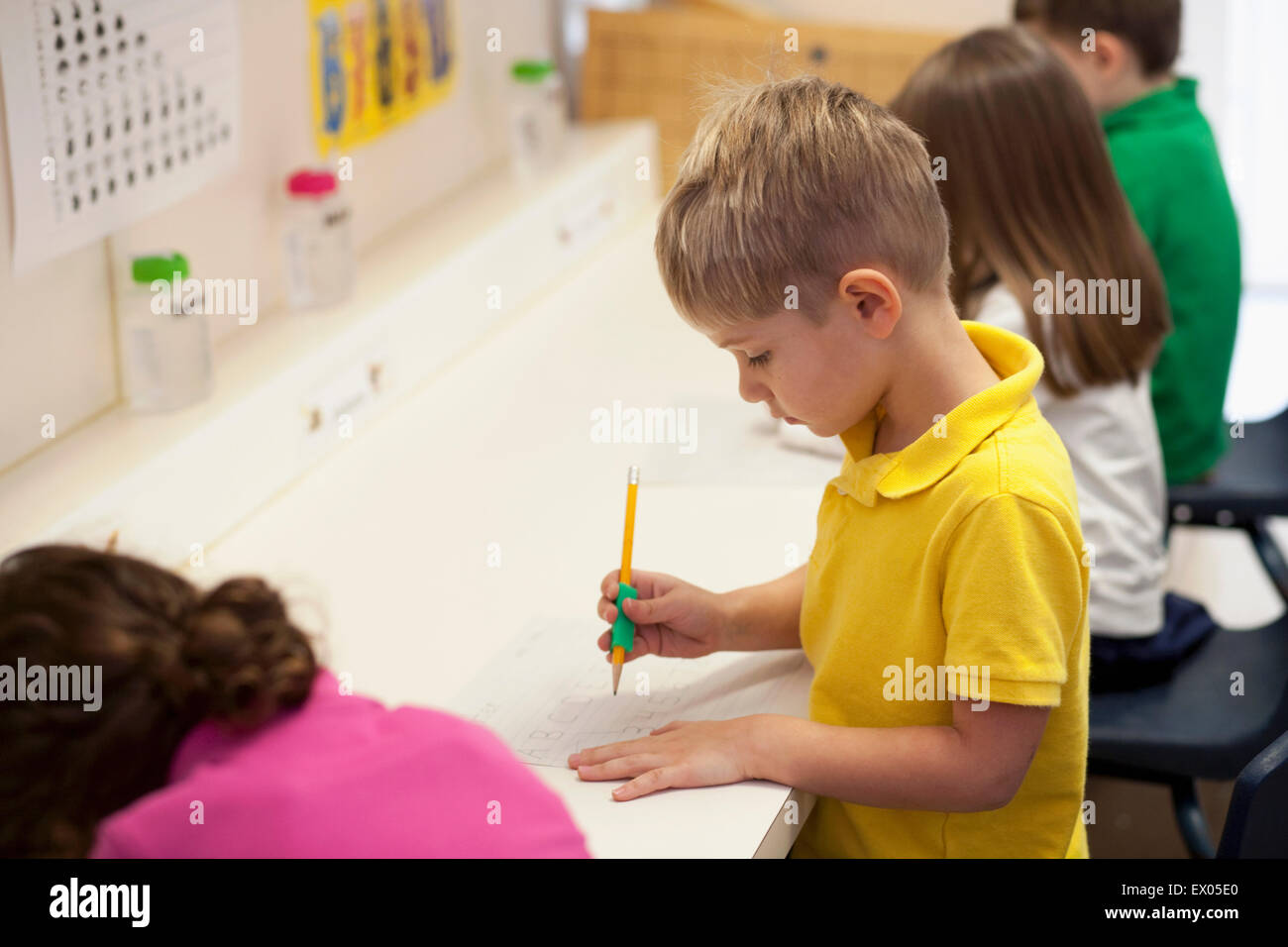 Toddlers writing in classroom Stock Photo - Alamy