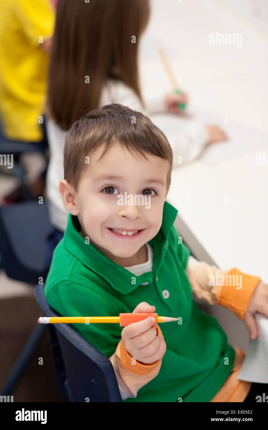 Toddler writing in classroom Stock Photo - Alamy