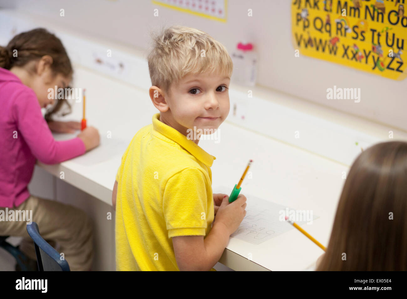 Toddlers writing in classroom Stock Photo - Alamy
