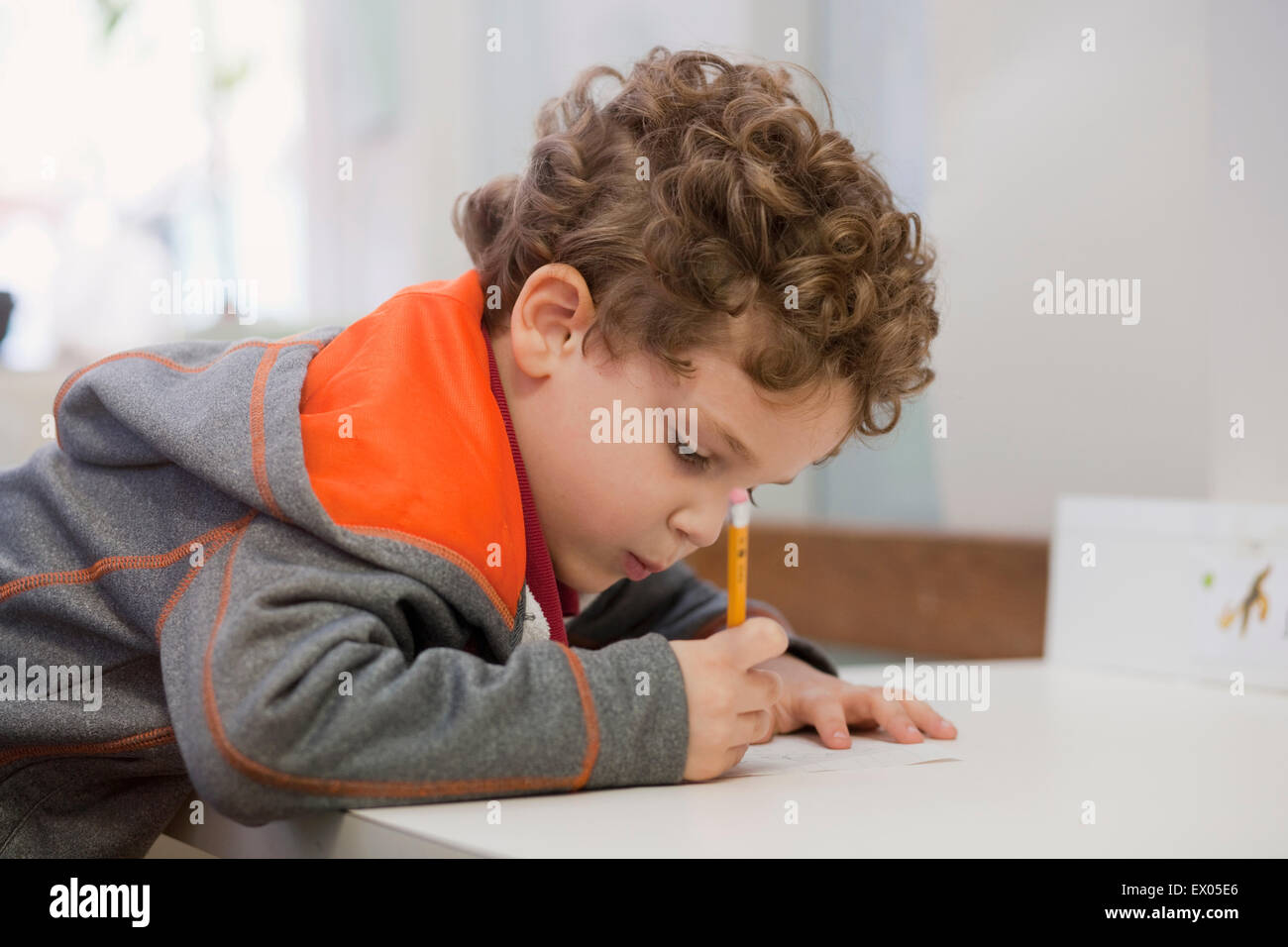 Toddler writing in classroom Stock Photo - Alamy