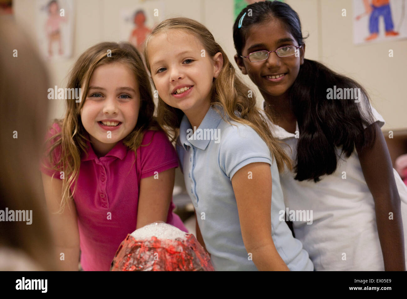 Girls with volcano model in classroom Stock Photo - Alamy