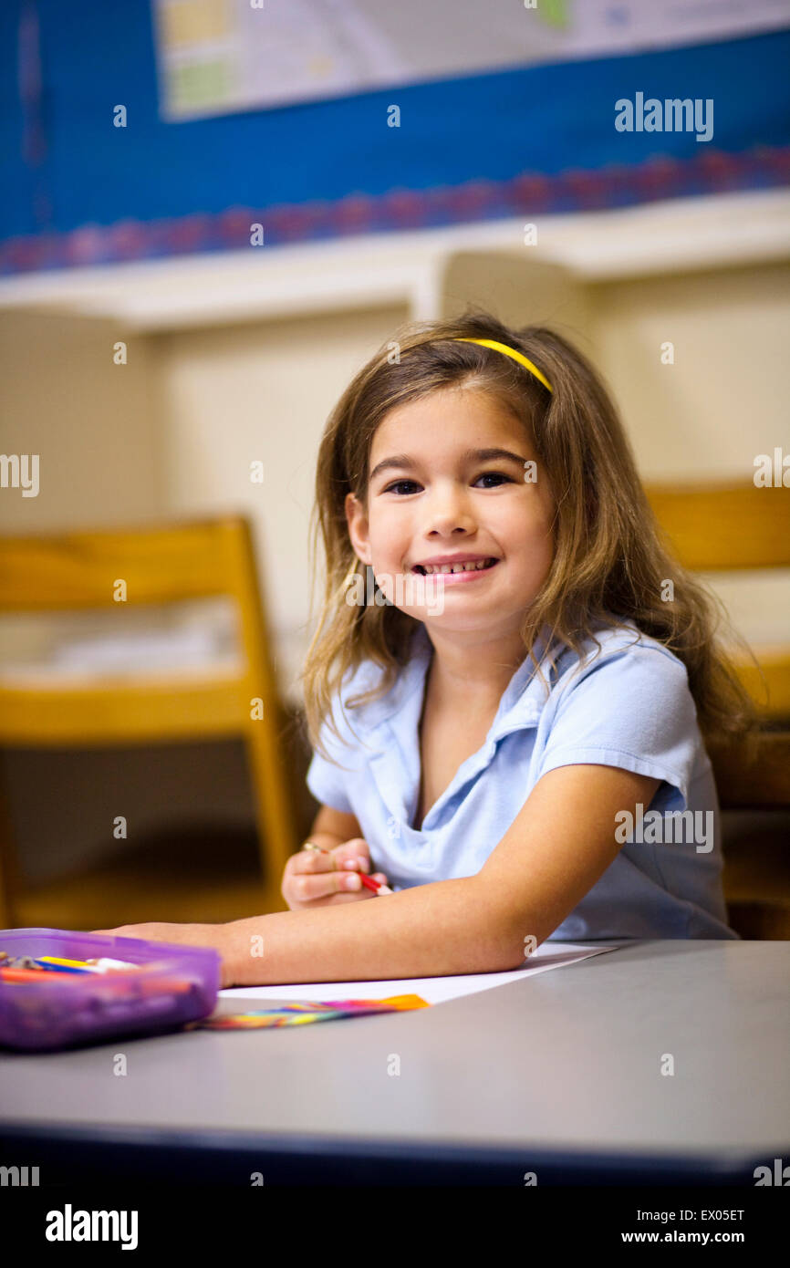 Girl smiling in classroom Stock Photo - Alamy
