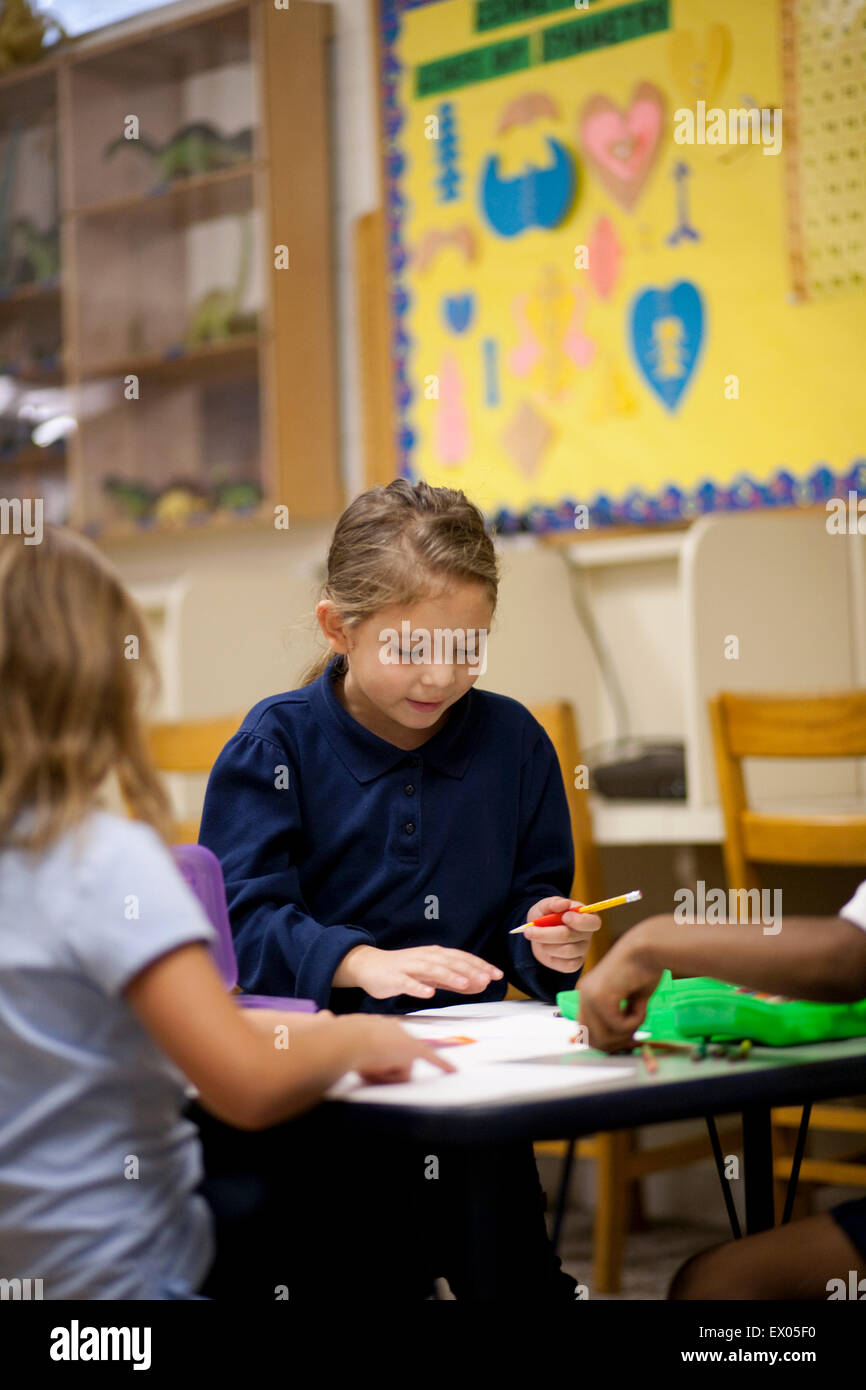 Children writing in classroom Stock Photo - Alamy