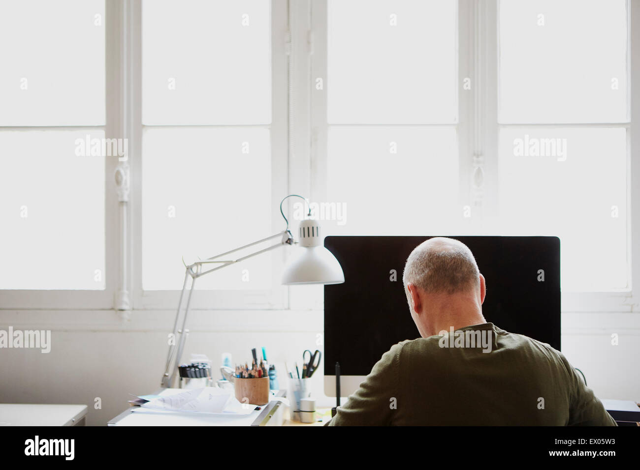 Rear view of working man hi-res stock photography and images - Alamy