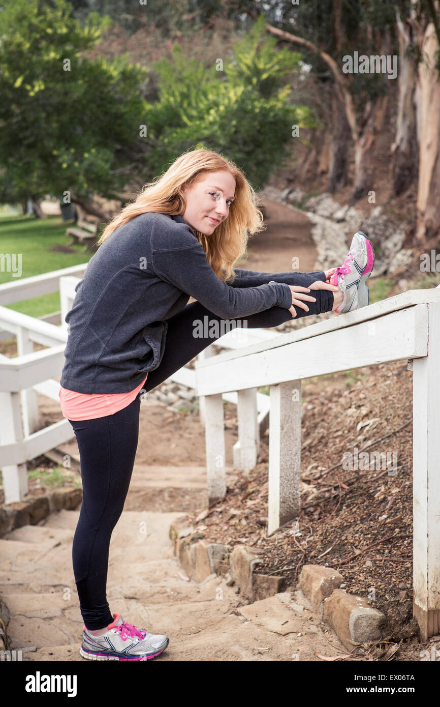 Young female runner warming up on park stairway Stock Photo - Alamy