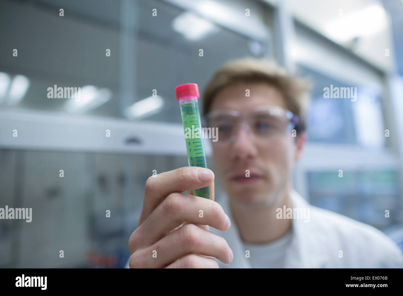 Close up of male scientist hand holding up test tube Stock Photo - Alamy