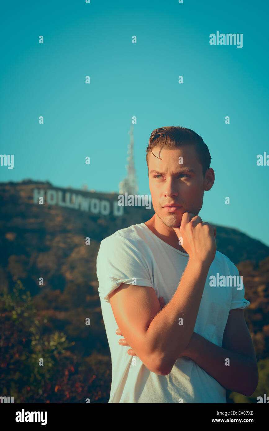 A vintage portrait of a young man, male model, posing in a white t ...