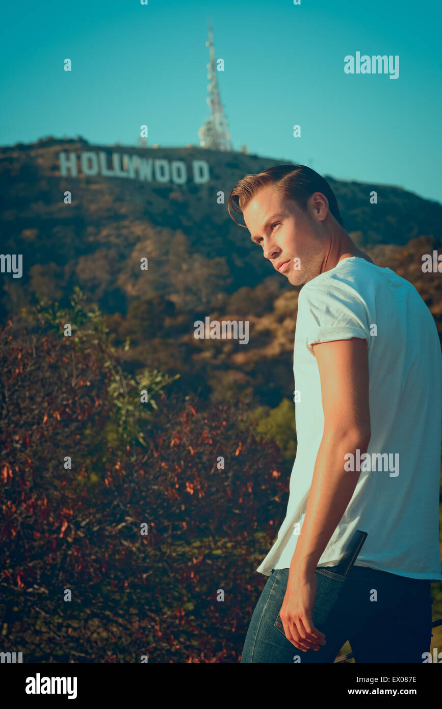 A vintage portrait of a young man, male model, posing in a white t ...