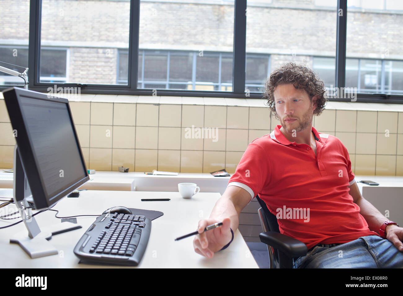 Man gazing at office desk Stock Photo - Alamy