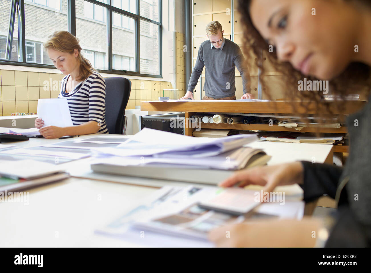 Designers busy at work in creative office Stock Photo - Alamy