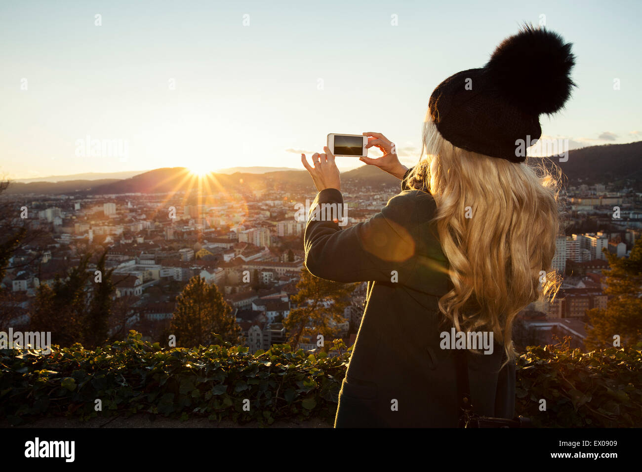 Mid adult woman taking photo on phone, Graz, Styria, Austria Stock ...