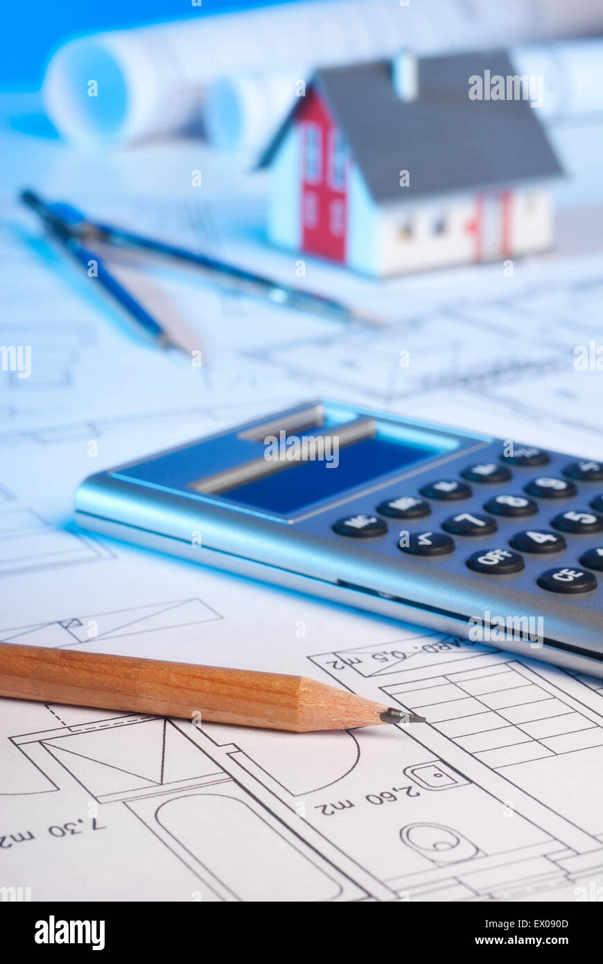 Architecture model with blueprints, calculator, compasses and pen Stock ...