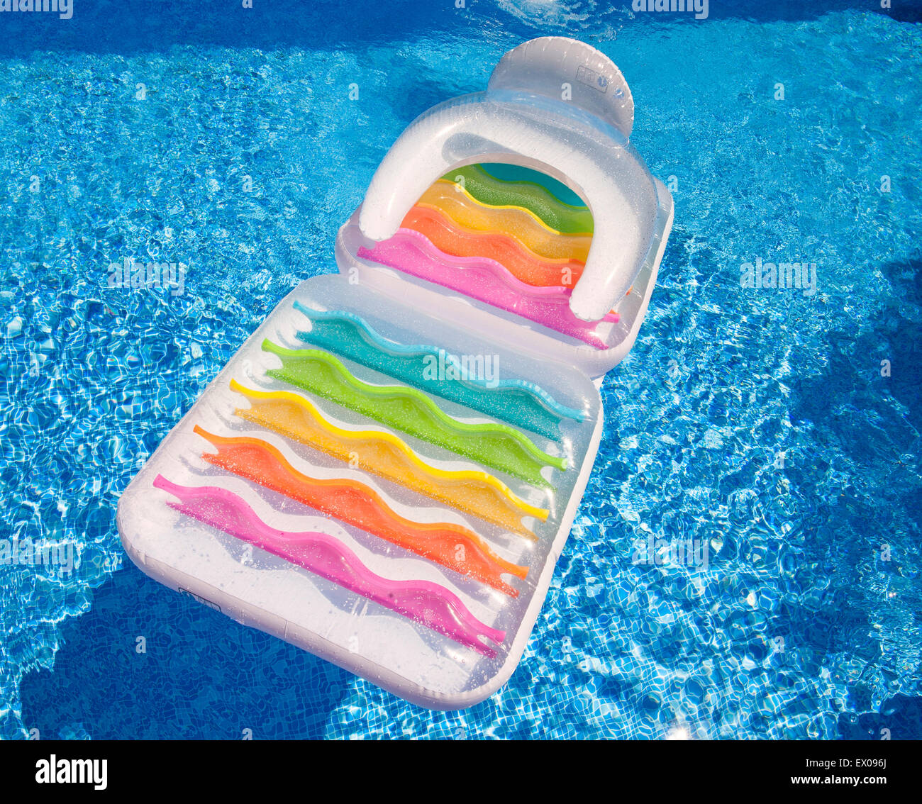 Colorful floating air mattress in swimming pool at summertime as ...