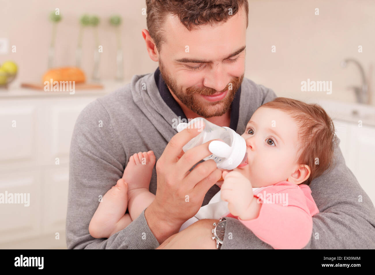 Nice daddy feeding his child Stock Photo - Alamy