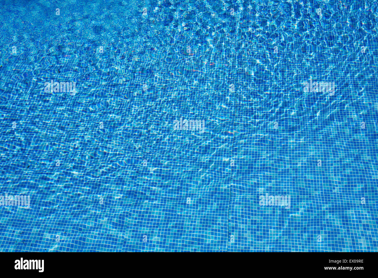 Sun reflected in the swimming pool water as a background Stock Photo ...