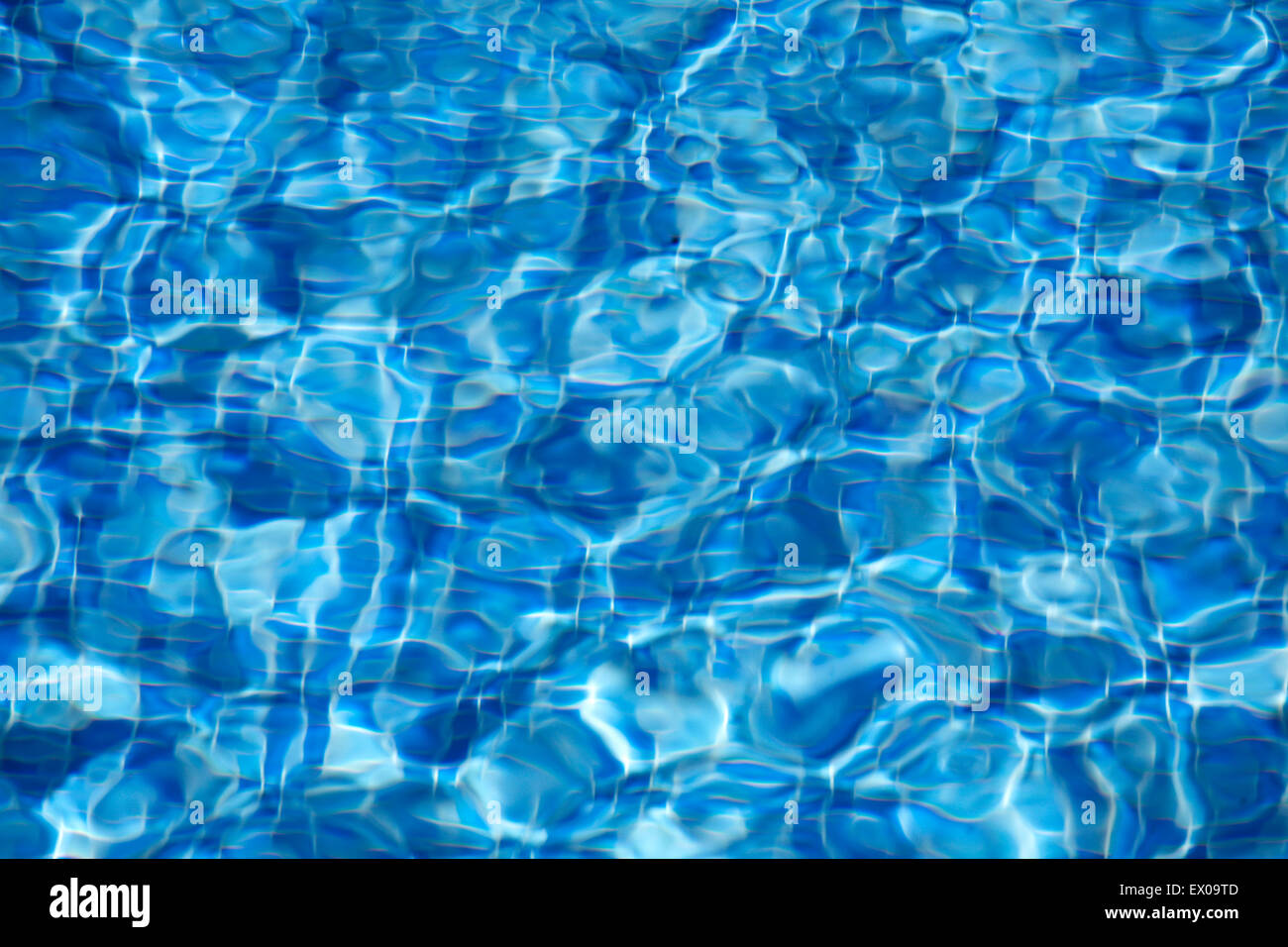 Sun reflected in the swimming pool water as a background Stock Photo ...
