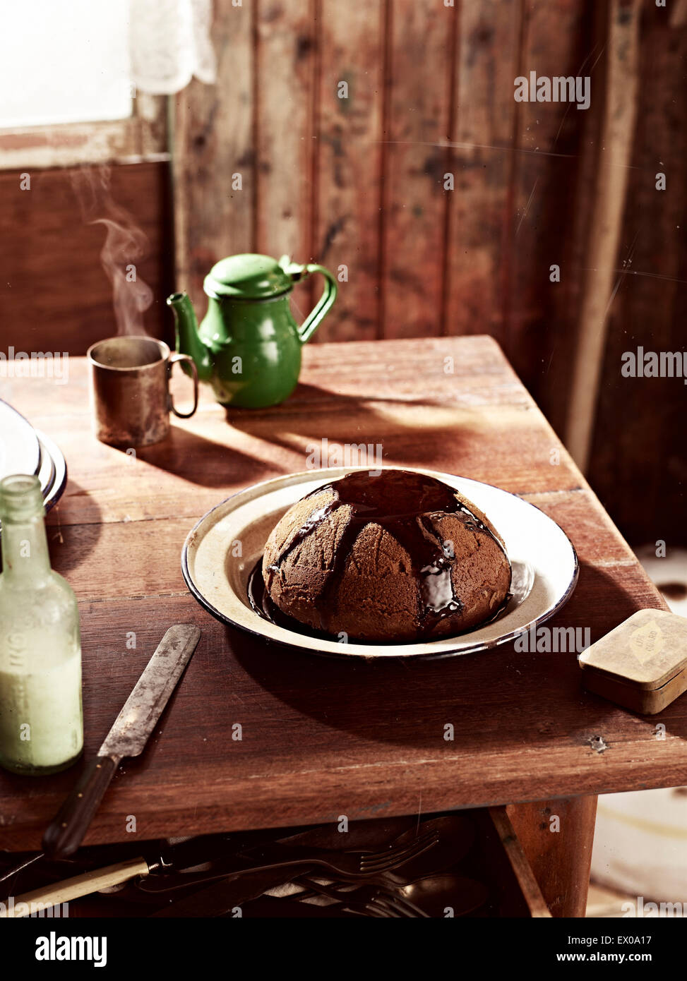 Rustic table with dish of steamed treacle pudding Stock Photo - Alamy