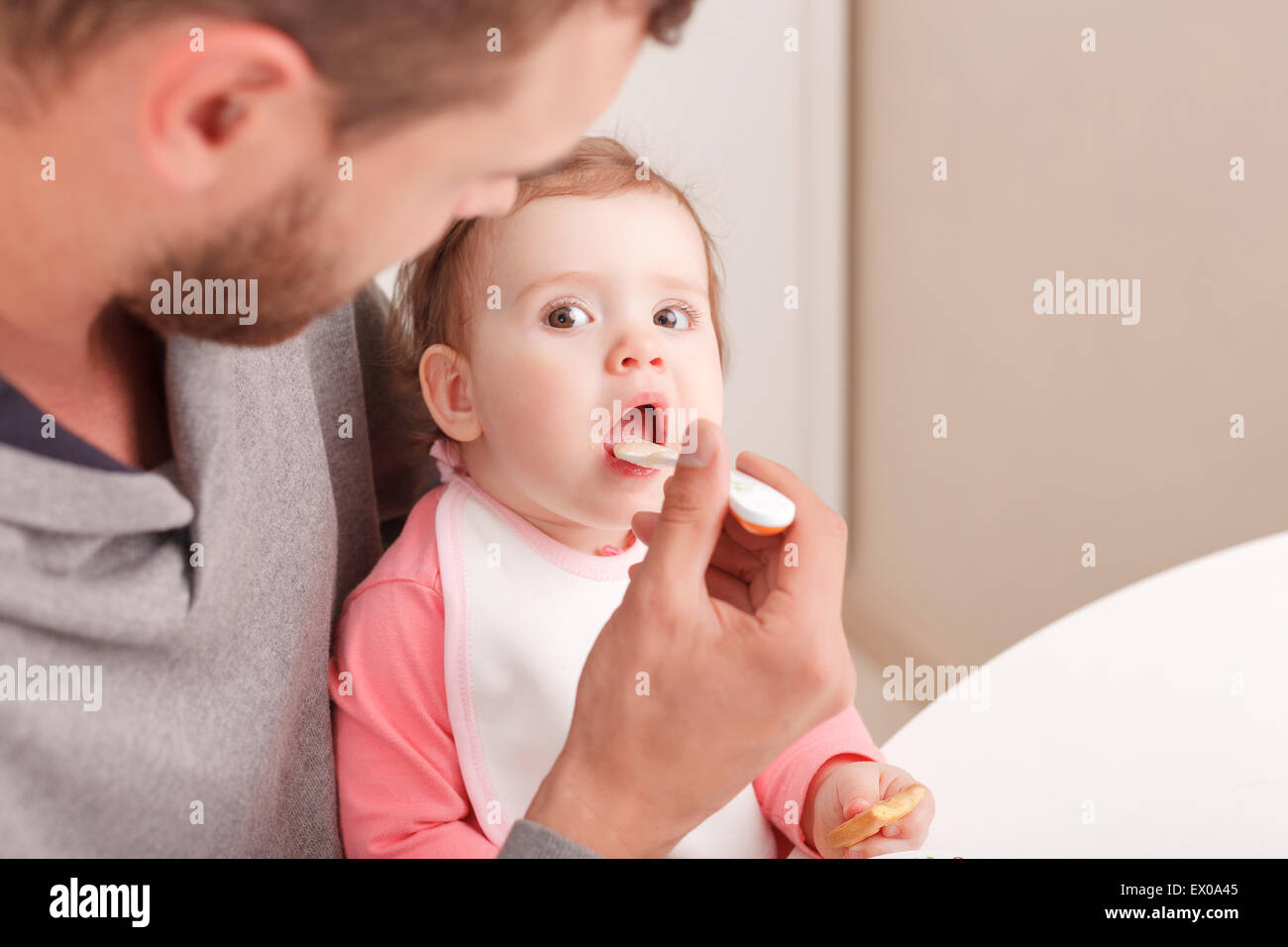 Nice daddy feeding his child Stock Photo - Alamy