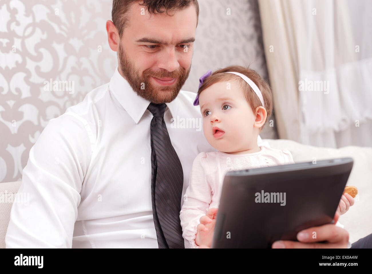 Positive father holding laptop Stock Photo - Alamy