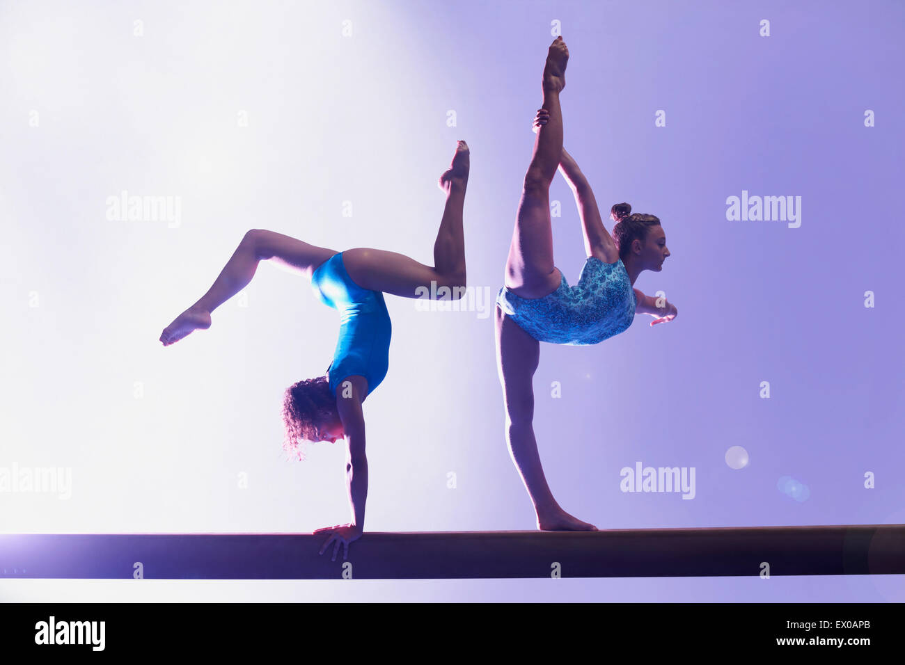 Gymnasts doing routine on bar Stock Photo - Alamy