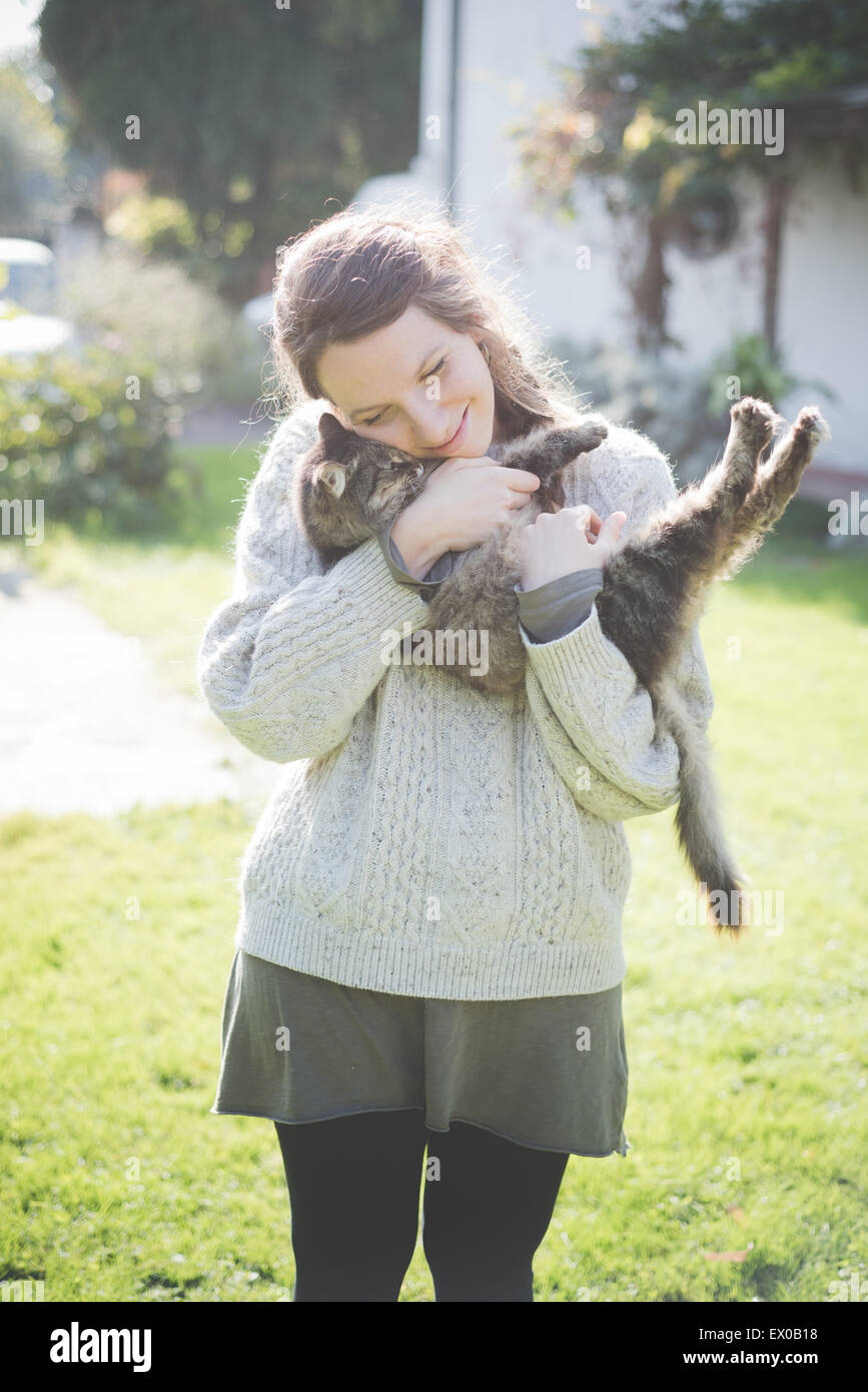 Young woman hugging cat Stock Photo - Alamy