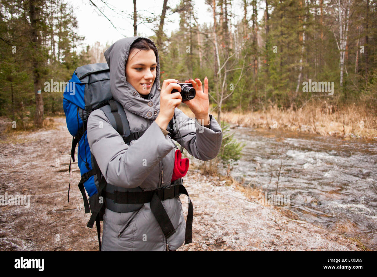 Female hiker photographing river on digital camera, Sarsy Village ...