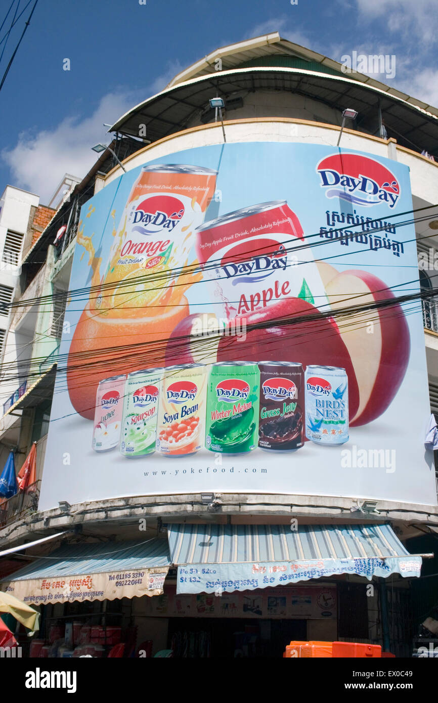 A large sign advertising Day Day apple and orange drinks rises above a ...