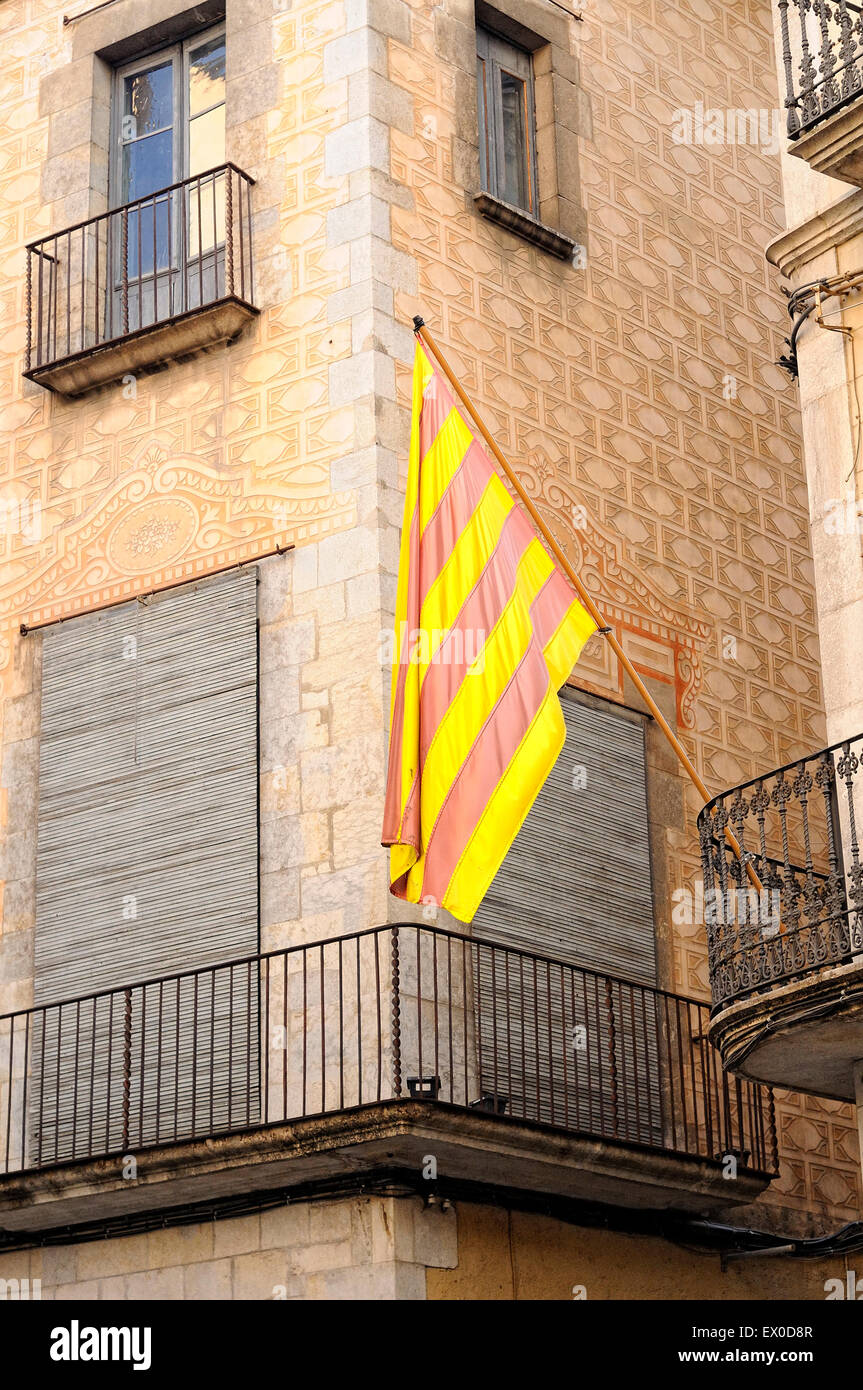 Catalonia independence flag hanging from a balcony of a facade. Girona ...