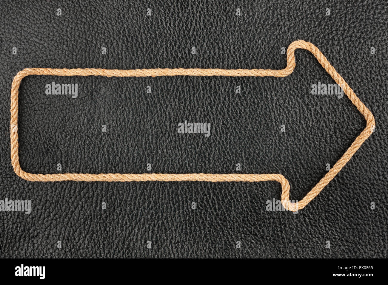 Pointer made of rope lying on the natural leather, with space for your ...