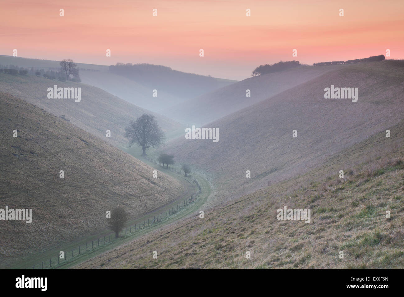 Meandering footpath through Horse Dale at sunrise close to the village ...