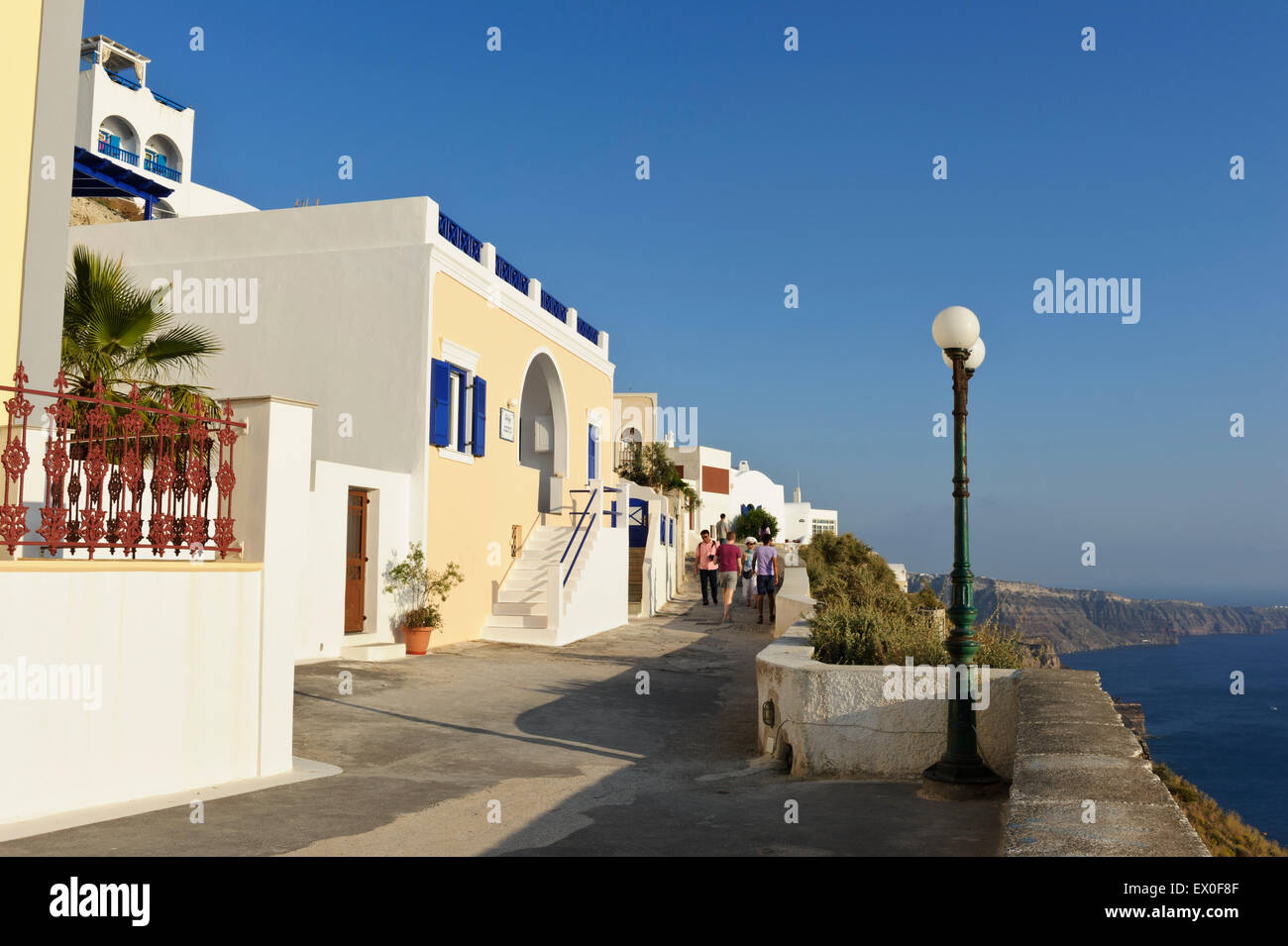 A walkway lined up with traditional houses on the Caldera in Fira ...