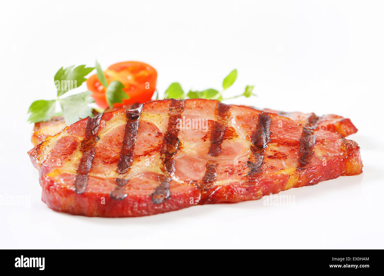 Slice of grilled pork neck on white background Stock Photo - Alamy