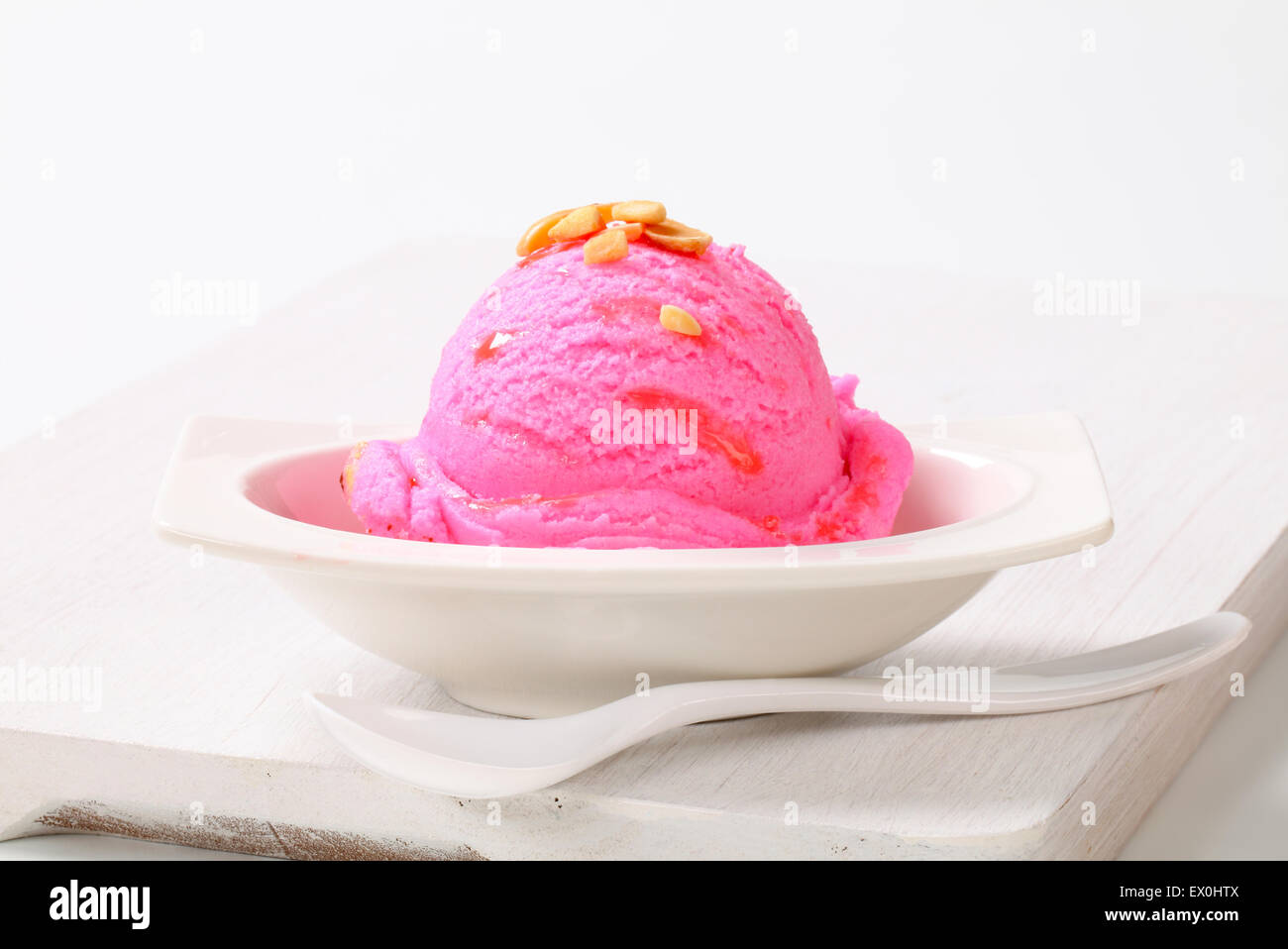 Scoop of pink ice cream on a dessert plate Stock Photo - Alamy