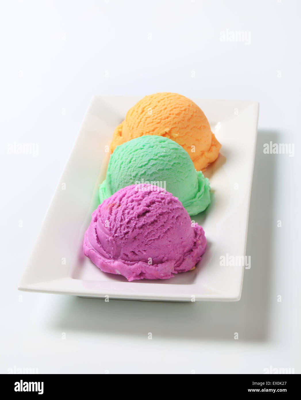 Three scoops of ice cream on long plate Stock Photo - Alamy