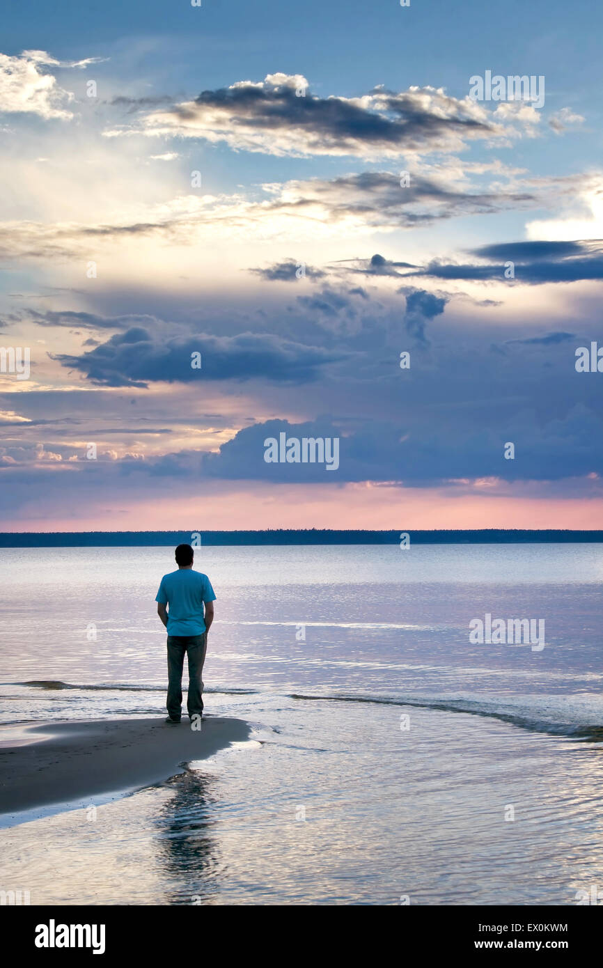 Alone man at sea in sunset Stock Photo - Alamy