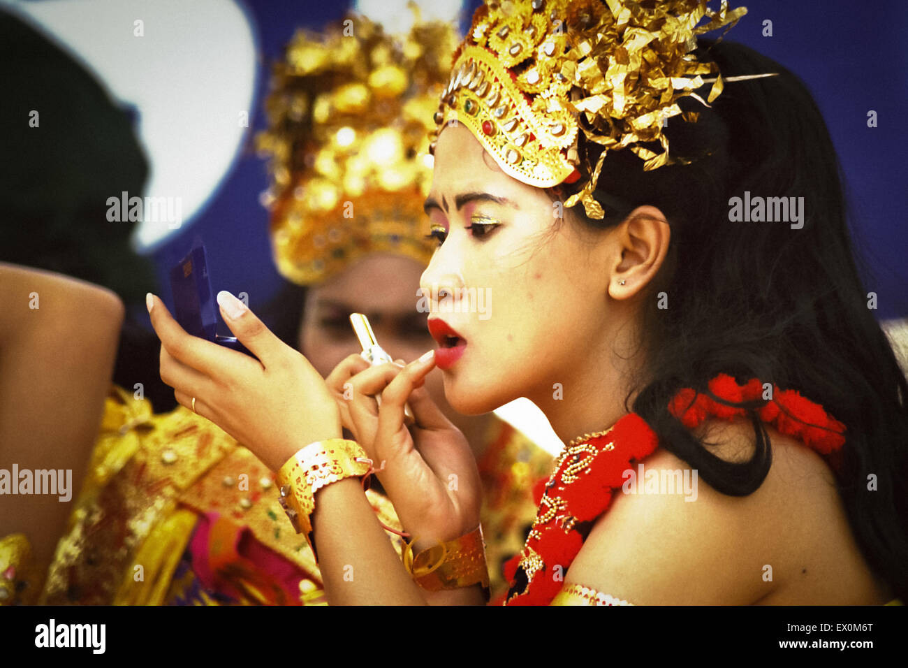 A traditional dancer preparing with makeup backstage during the Jakarta ...