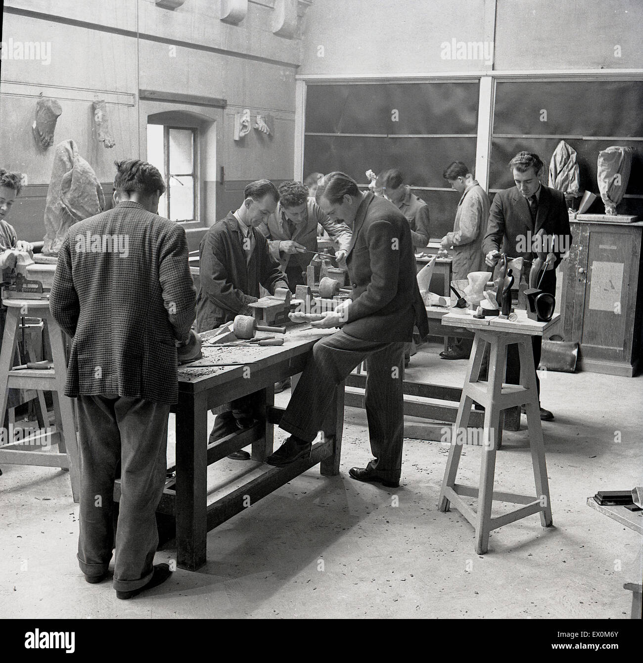 1950s historical, group of males in suits working in a carpentry ...